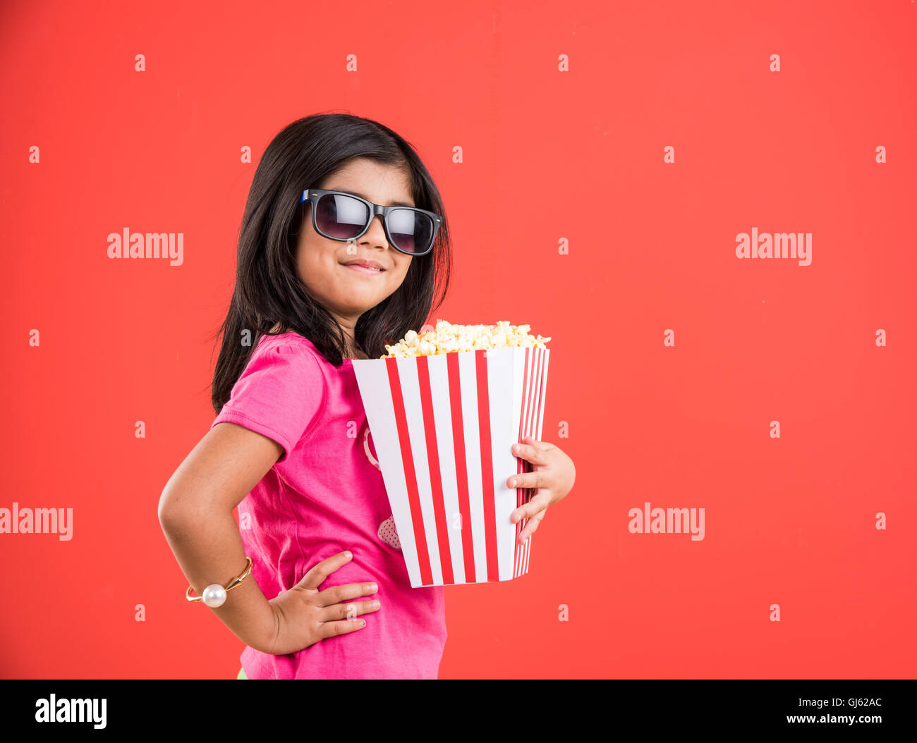 happy girl eating popcorn, indian girl eating popcorn, asian girl and ...