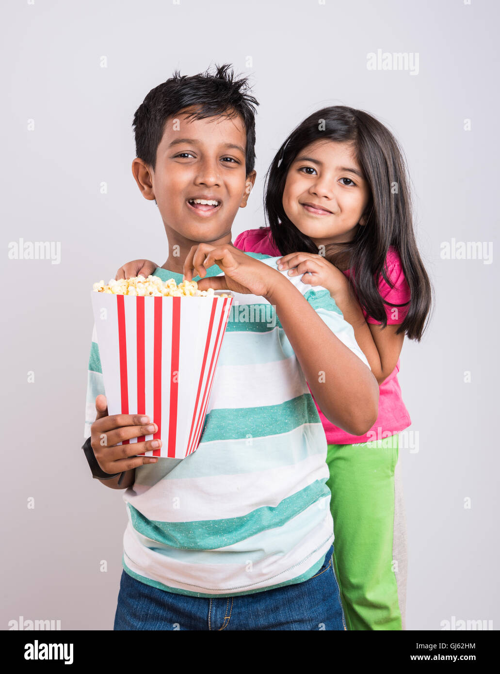 indian cute girl and boy eating popcorn, asian kids and popcorn, Little ...