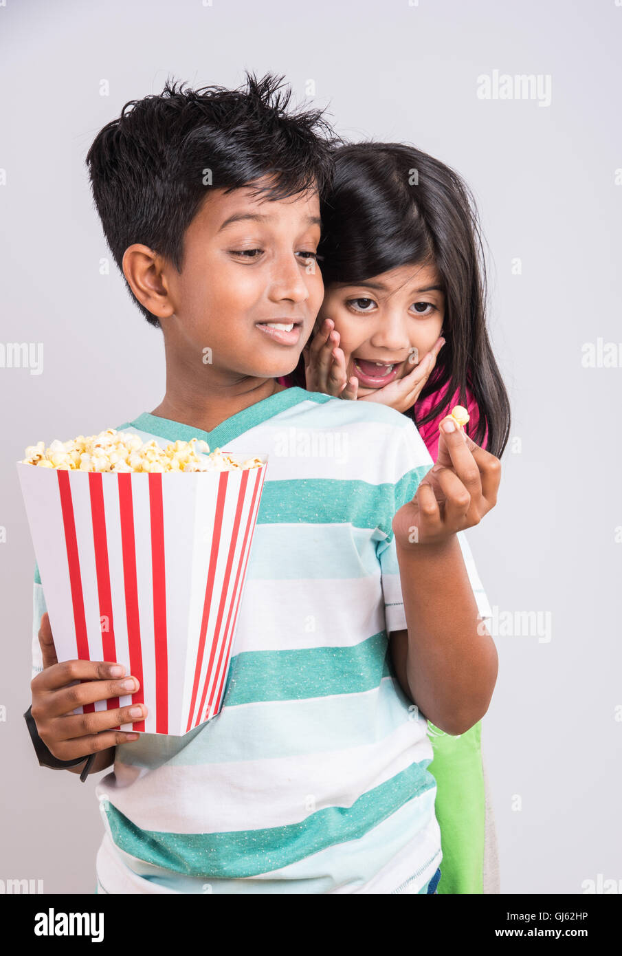 indian cute girl and boy eating popcorn, asian kids and popcorn, Little ...