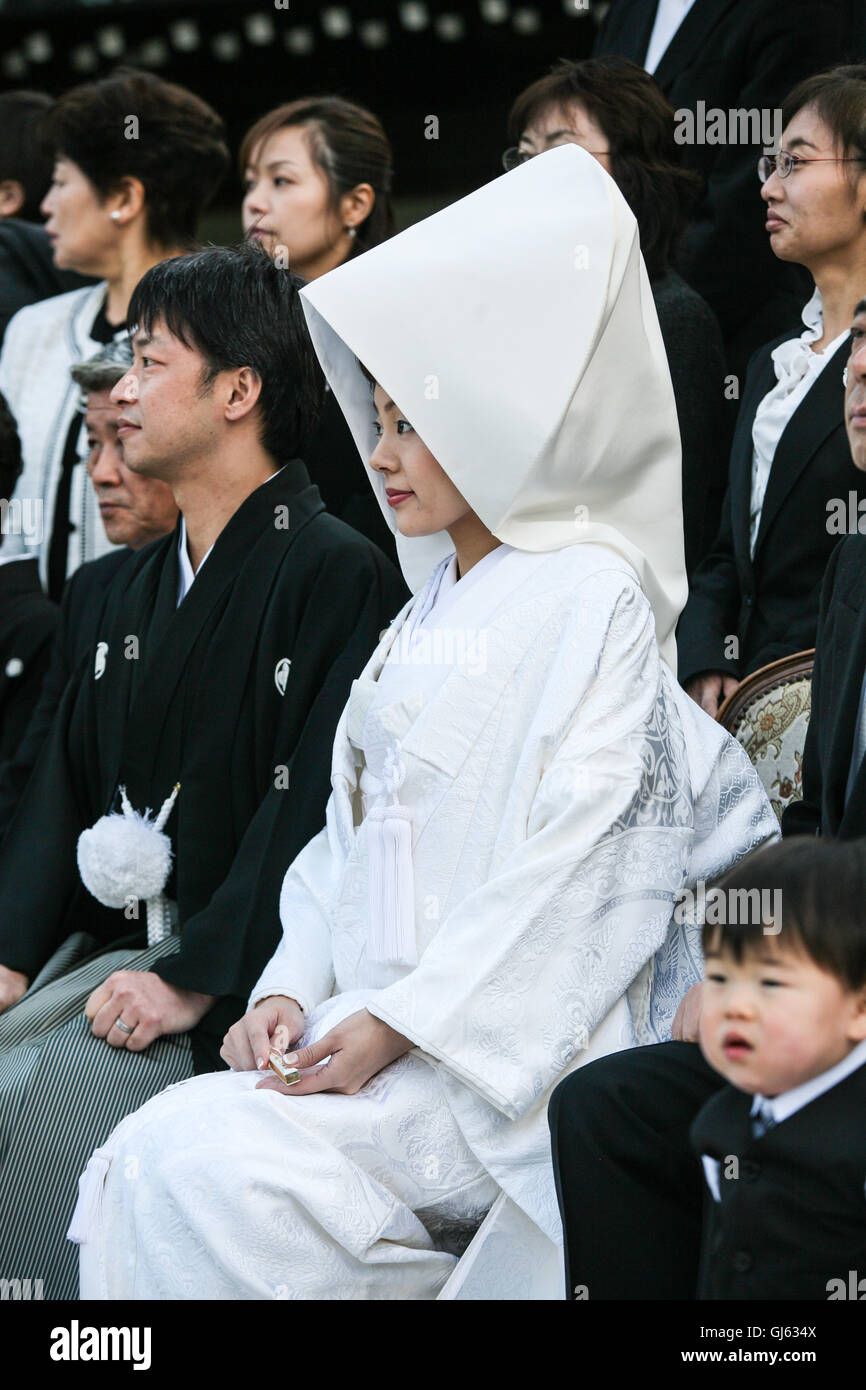 At a traditional Japanese Shinto wedding ceremony, the bride and groom ...