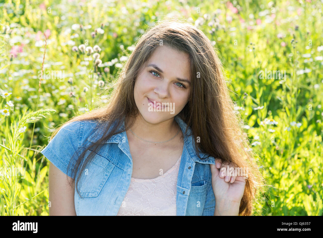 15 year girl with long brown hair on summer glade Stock Photo - Alamy