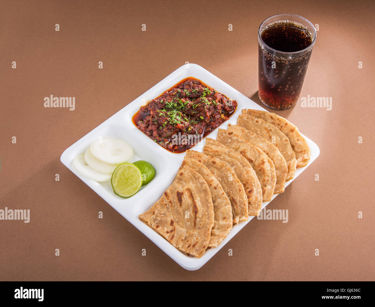 Indian lamb korma curry and indian bread or roti, with cold drink ...