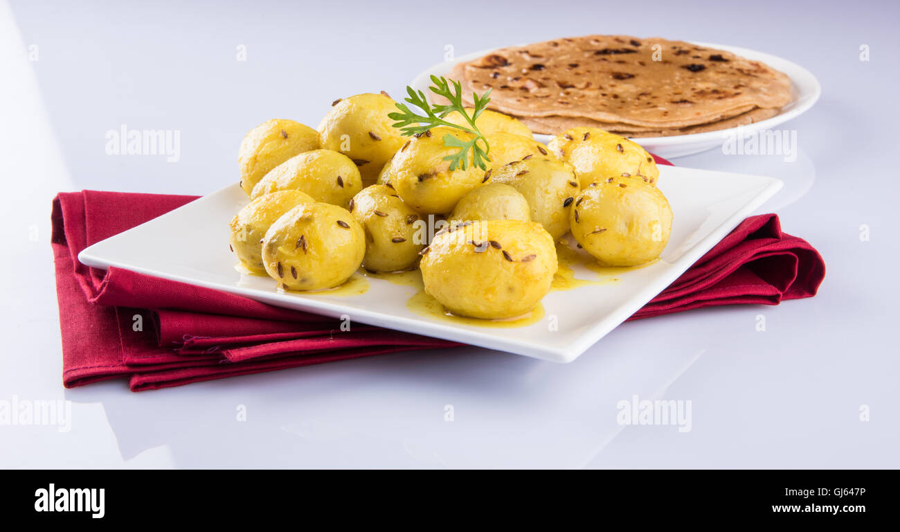 dry potato curry or potato bhaji or aalu bhaji and chapati or paratha ...