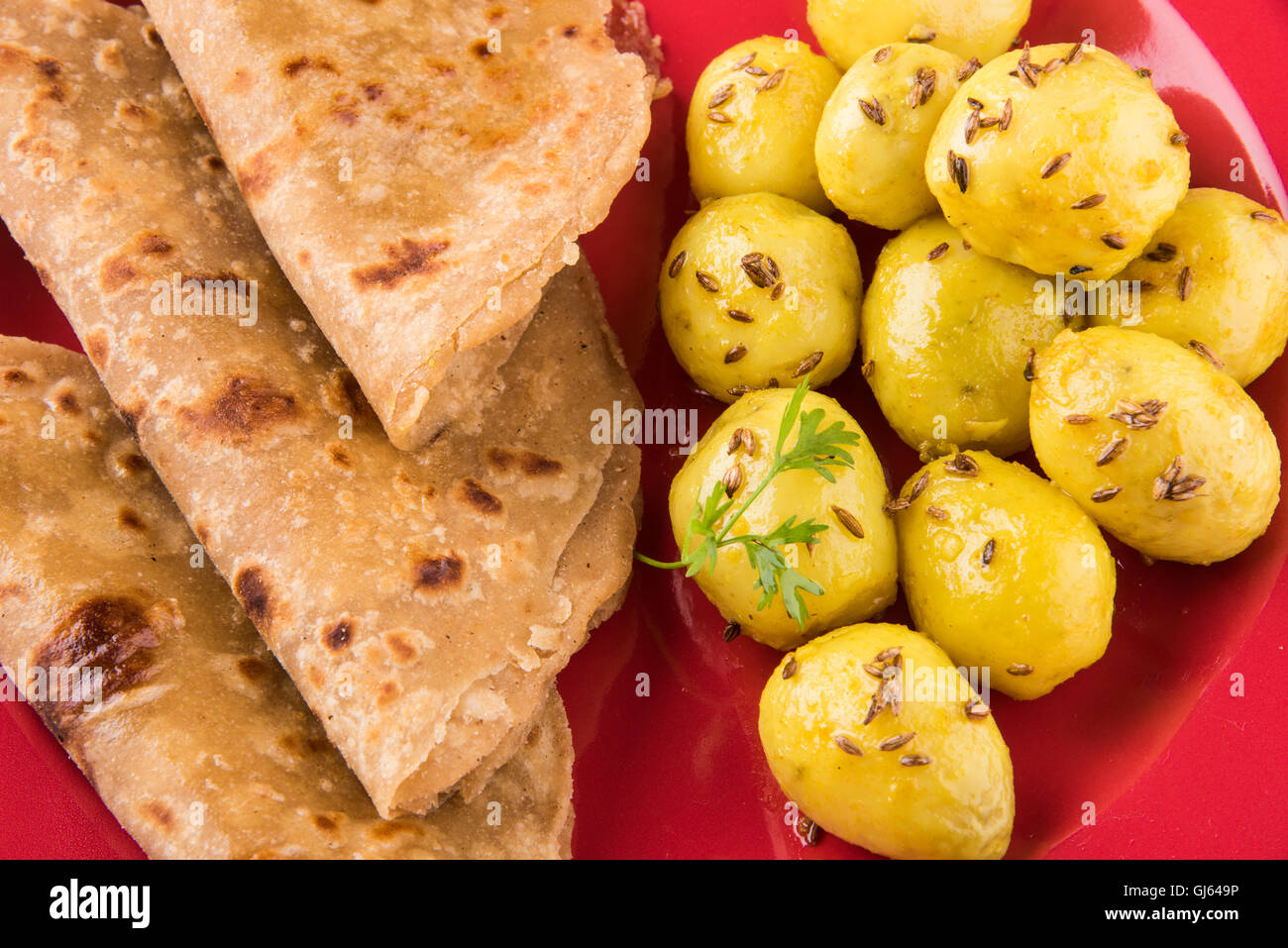 aloo fry or dry potato curry with chapati or roti or indian bread Stock ...
