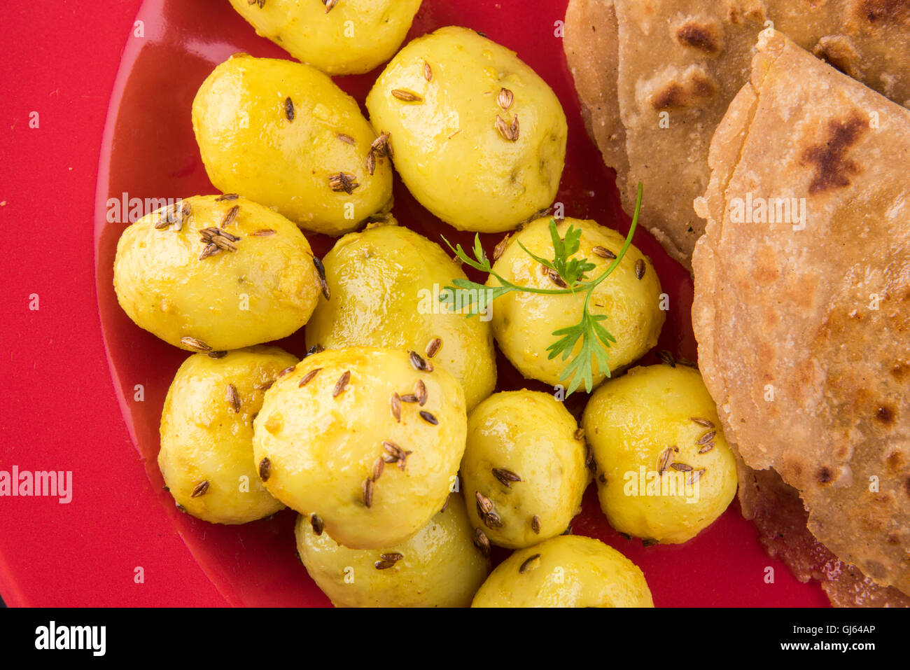 aloo fry or dry potato curry with chapati or roti or indian bread Stock ...