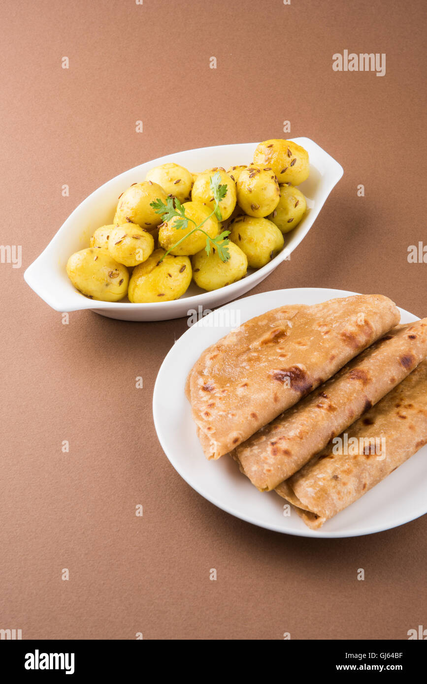 dry potato curry or potato bhaji or aalu bhaji and chapati or paratha ...
