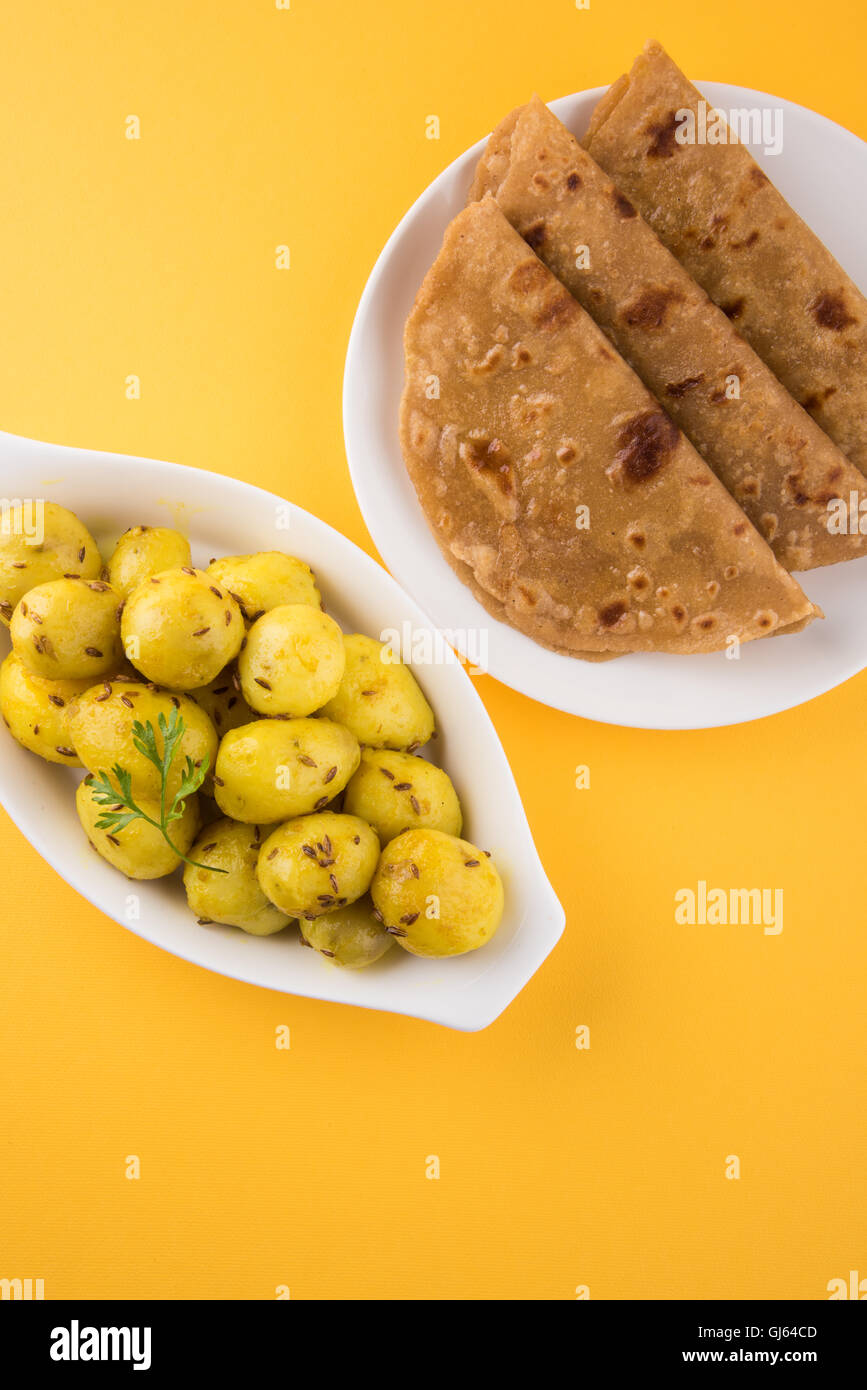 dry potato curry or potato bhaji or aalu bhaji and chapati or paratha ...