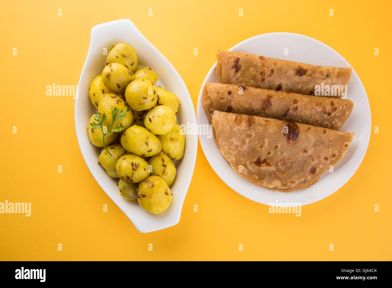 dry potato curry or potato bhaji or aalu bhaji and chapati or paratha ...