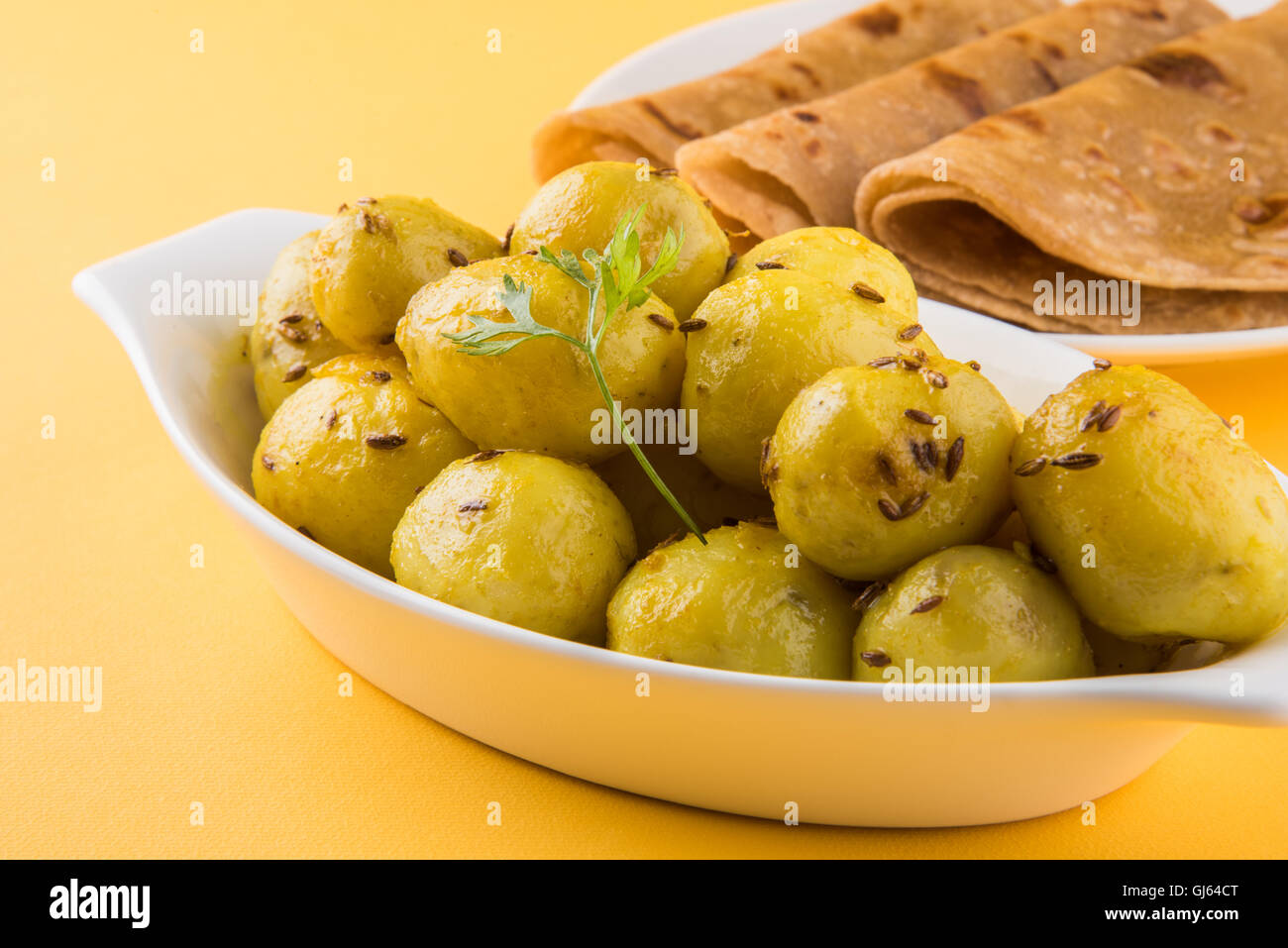 dry potato curry or potato bhaji or aalu bhaji and chapati or paratha ...