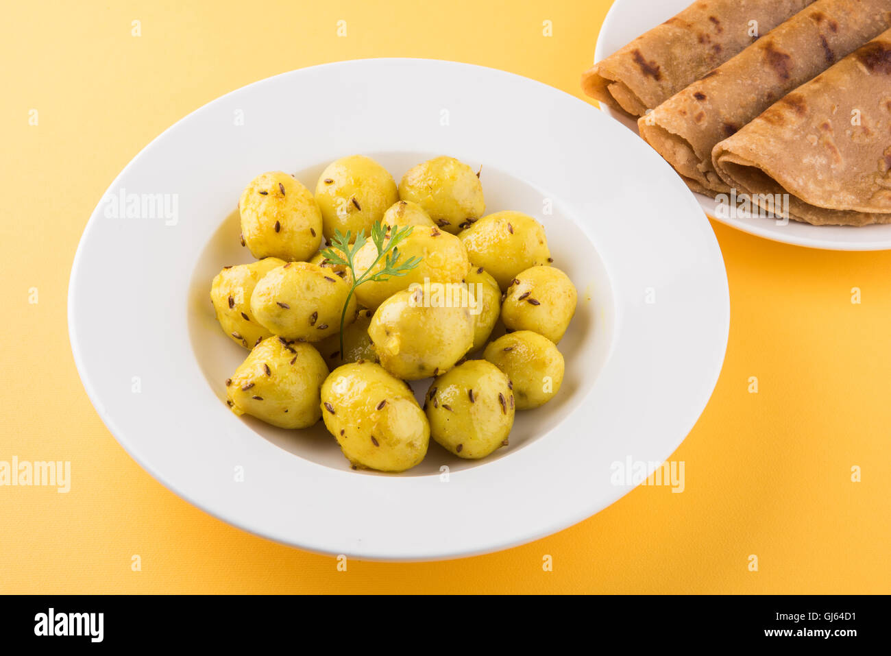 dry potato curry or potato bhaji or aalu bhaji and chapati or paratha ...