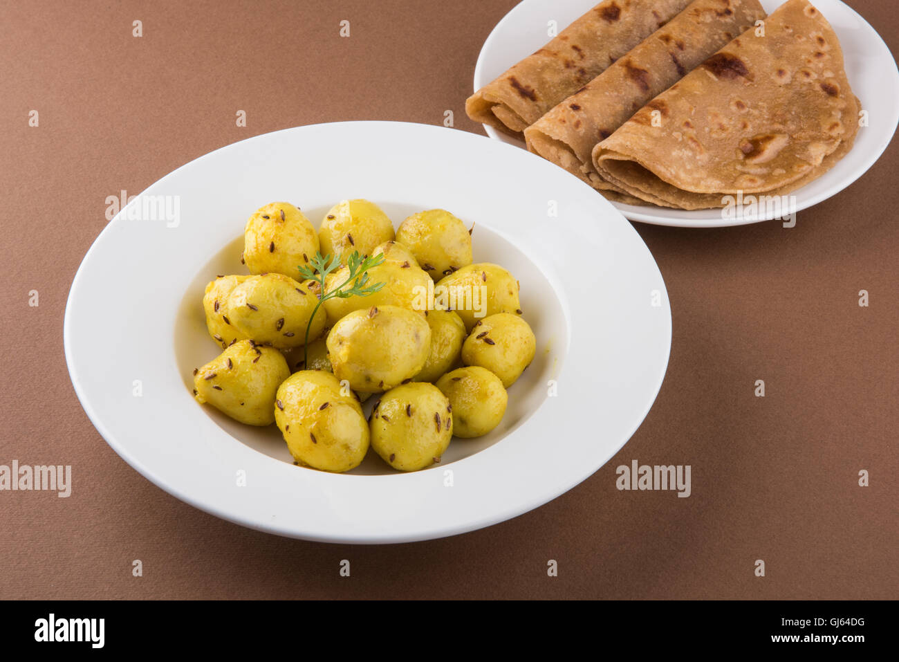 dry potato curry or potato bhaji or aalu bhaji and chapati or paratha ...