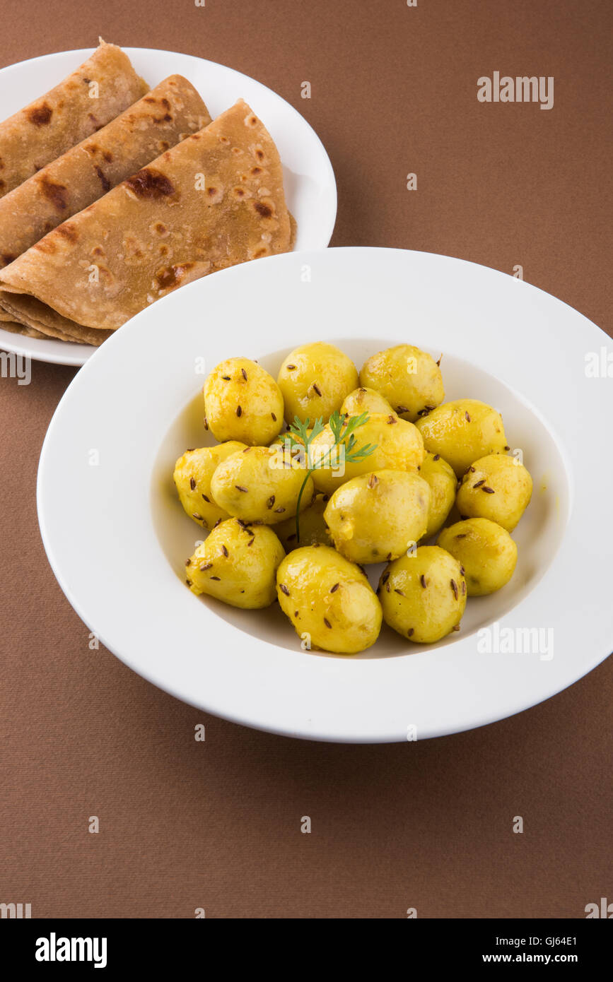 dry potato curry or potato bhaji or aalu bhaji and chapati or paratha ...