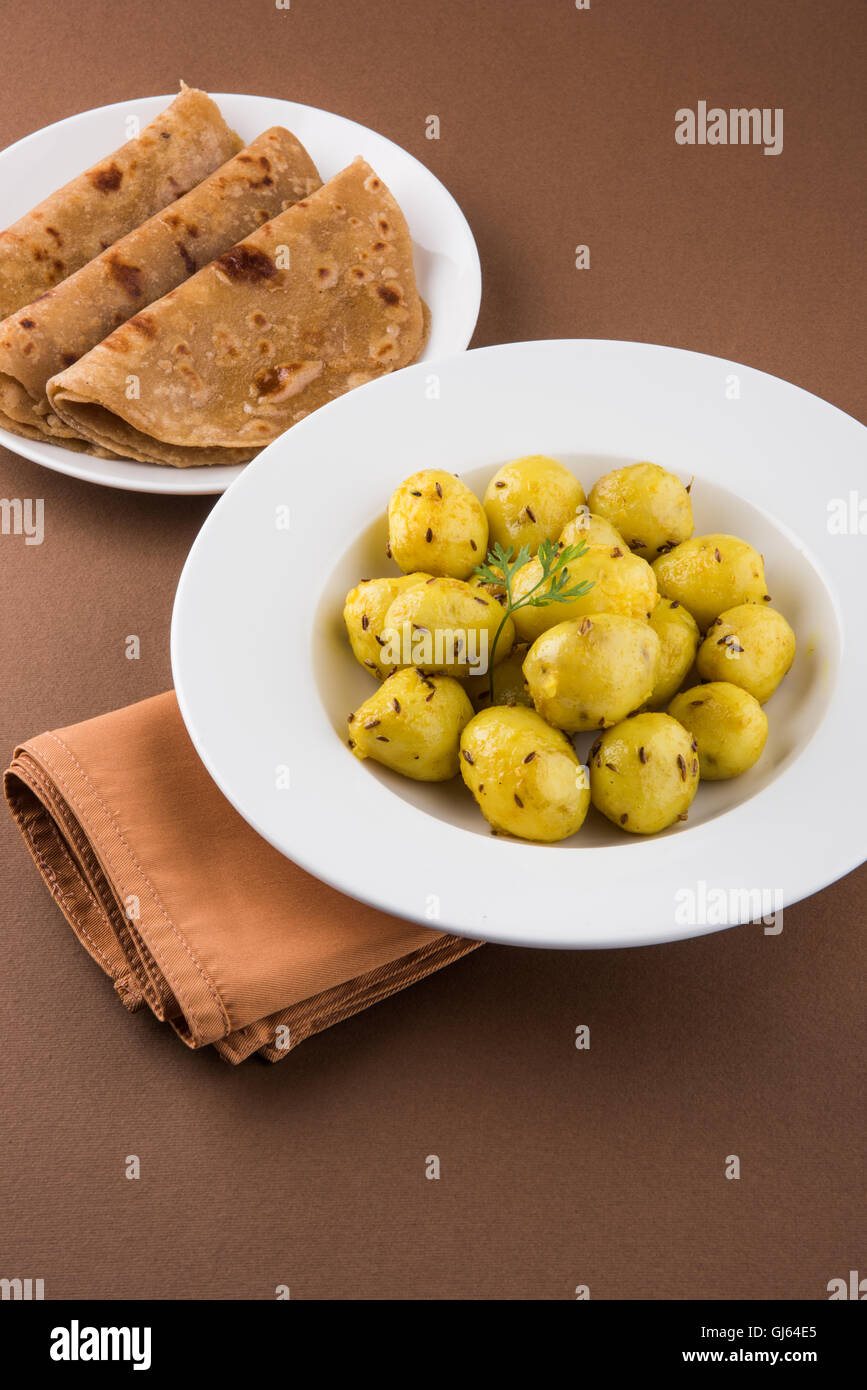 dry potato curry or potato bhaji or aalu bhaji and chapati or paratha ...