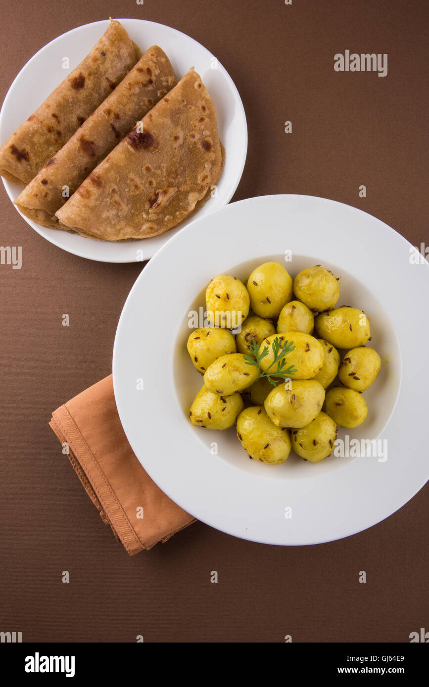 dry potato curry or potato bhaji or aalu bhaji and chapati or paratha ...