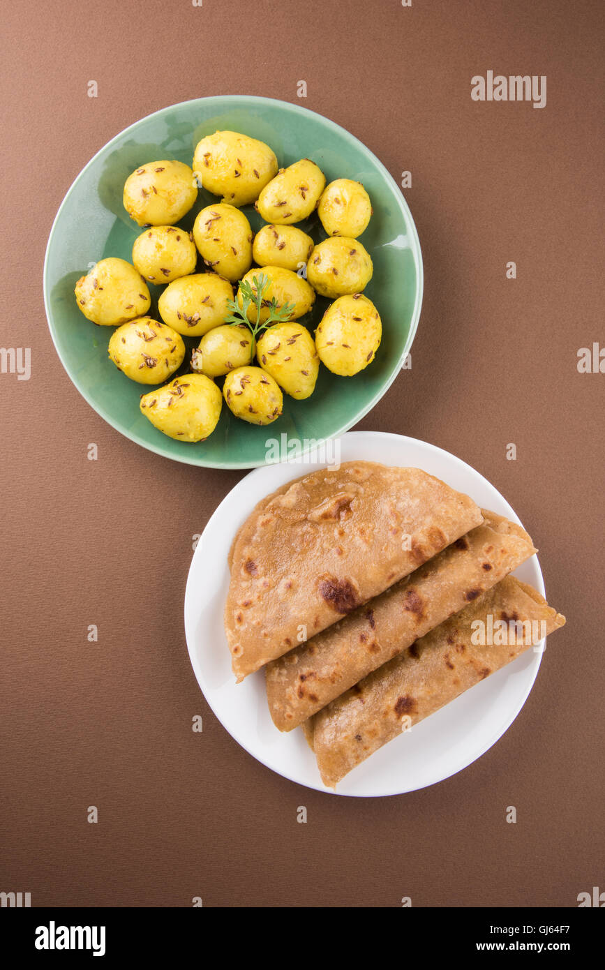 dry potato curry or potato bhaji or aalu bhaji and chapati or paratha ...