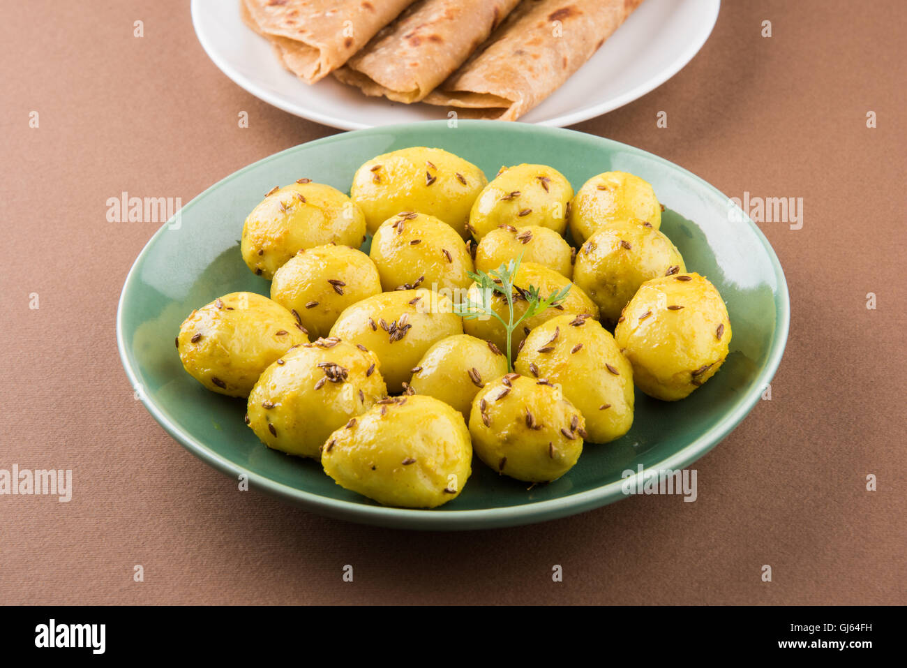 dry potato curry or potato bhaji or aalu bhaji and chapati or paratha ...