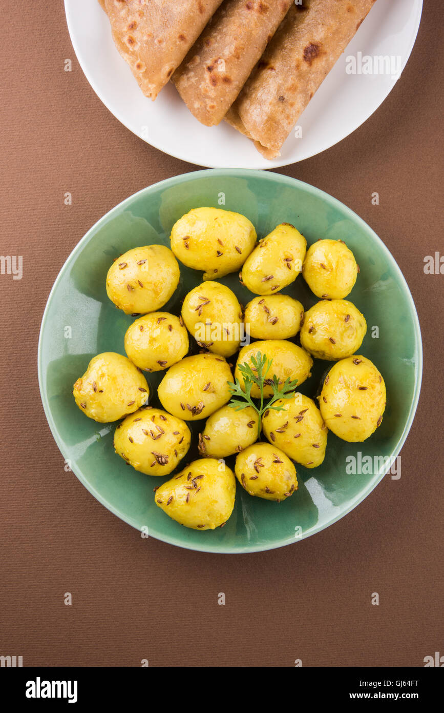 dry potato curry or potato bhaji or aalu bhaji and chapati or paratha ...