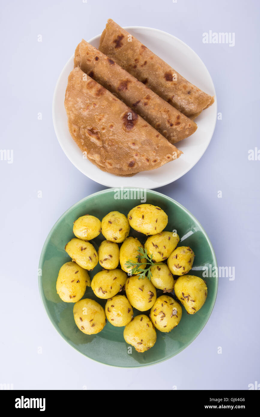 dry potato curry or potato bhaji or aalu bhaji and chapati or paratha ...