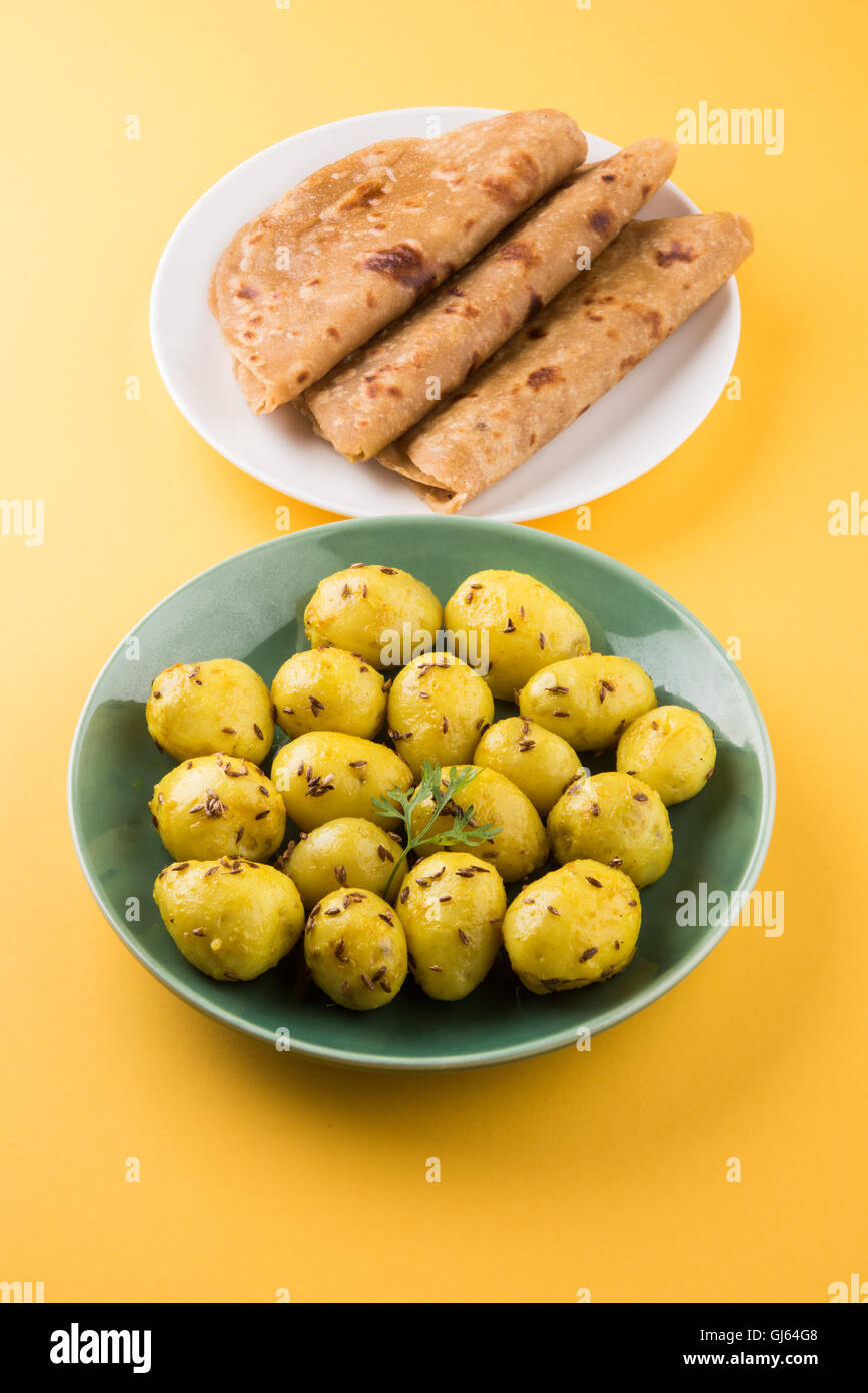 dry potato curry or potato bhaji or aalu bhaji and chapati or paratha ...