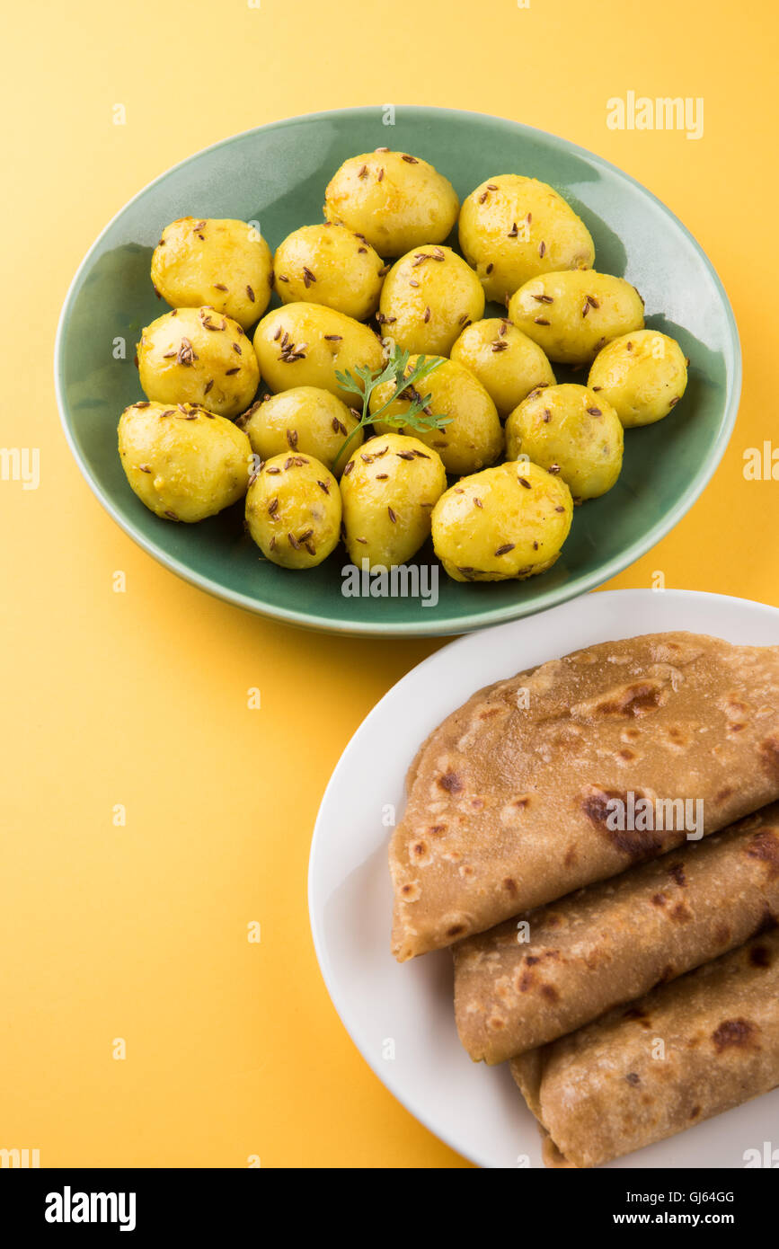 dry potato curry or potato bhaji or aalu bhaji and chapati or paratha ...