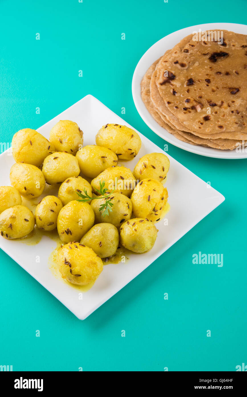 dry potato curry or potato bhaji or aalu bhaji and chapati or paratha ...
