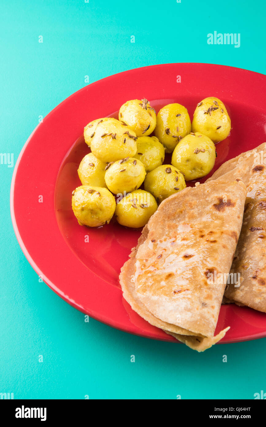 dry potato curry or potato bhaji or aalu bhaji and chapati or paratha ...