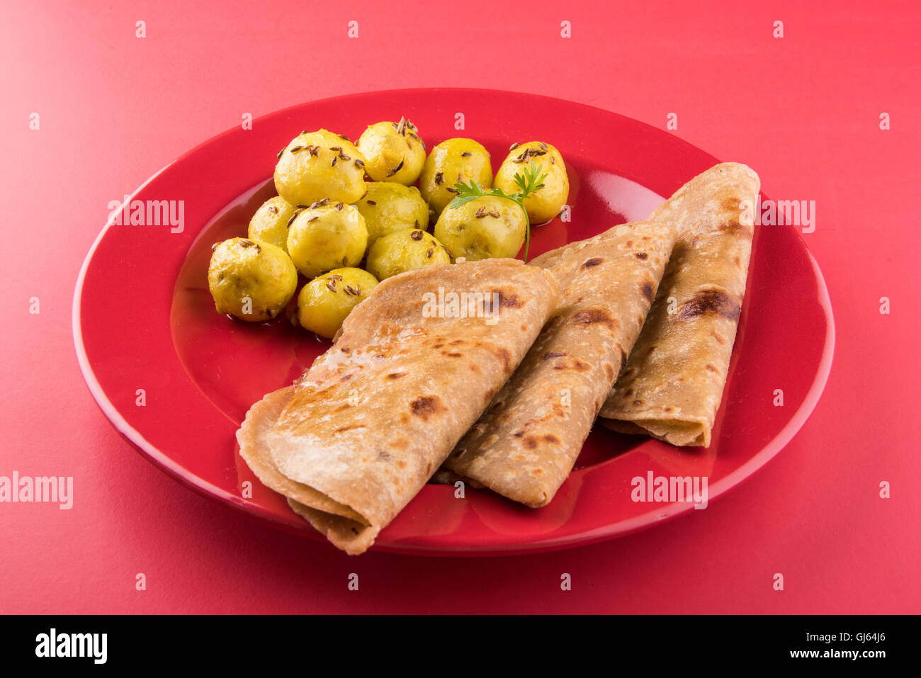 dry potato curry or potato bhaji or aalu bhaji and chapati or paratha ...