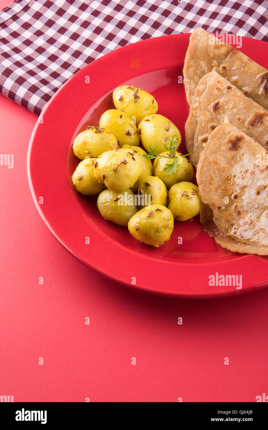 dry potato curry or potato bhaji or aalu bhaji and chapati or paratha ...