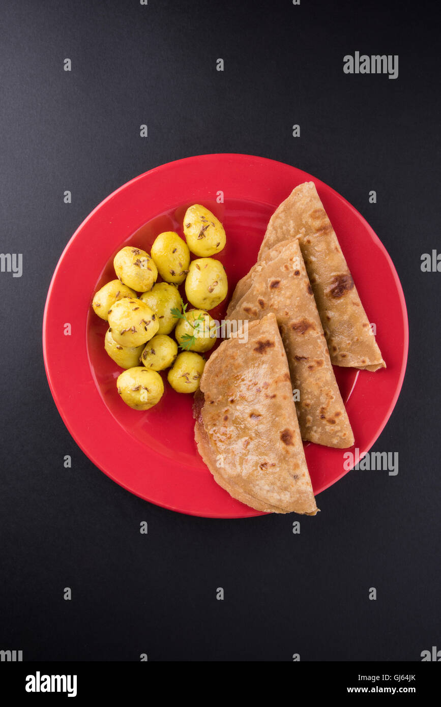 dry potato curry or potato bhaji or aalu bhaji and chapati or paratha ...