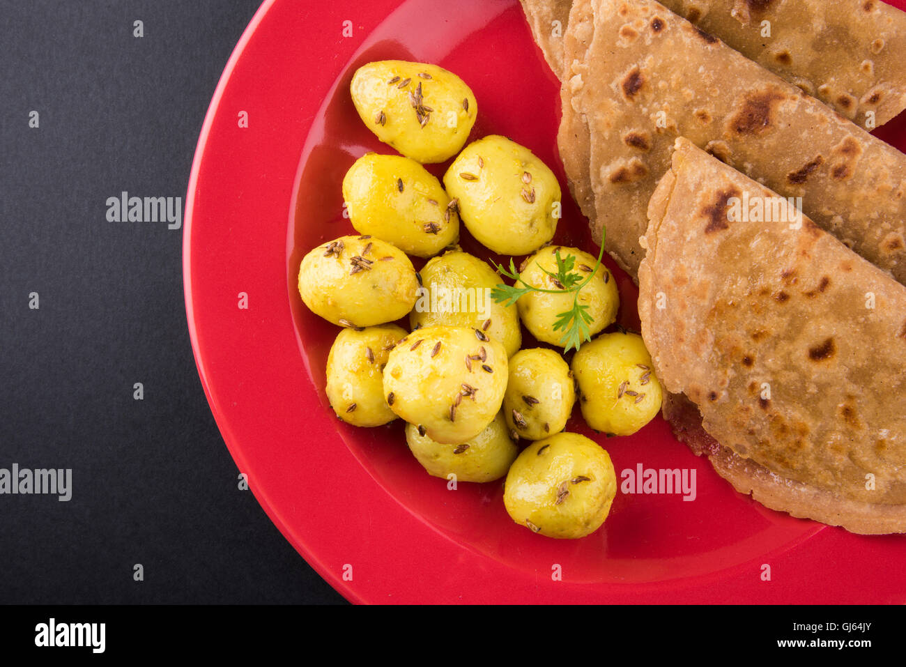 dry potato curry or potato bhaji or aalu bhaji and chapati or paratha ...