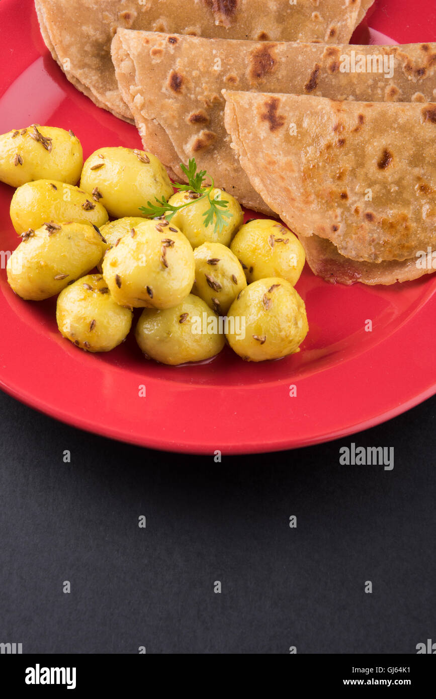 aloo fry or dry potato curry with chapati or roti or indian bread Stock ...