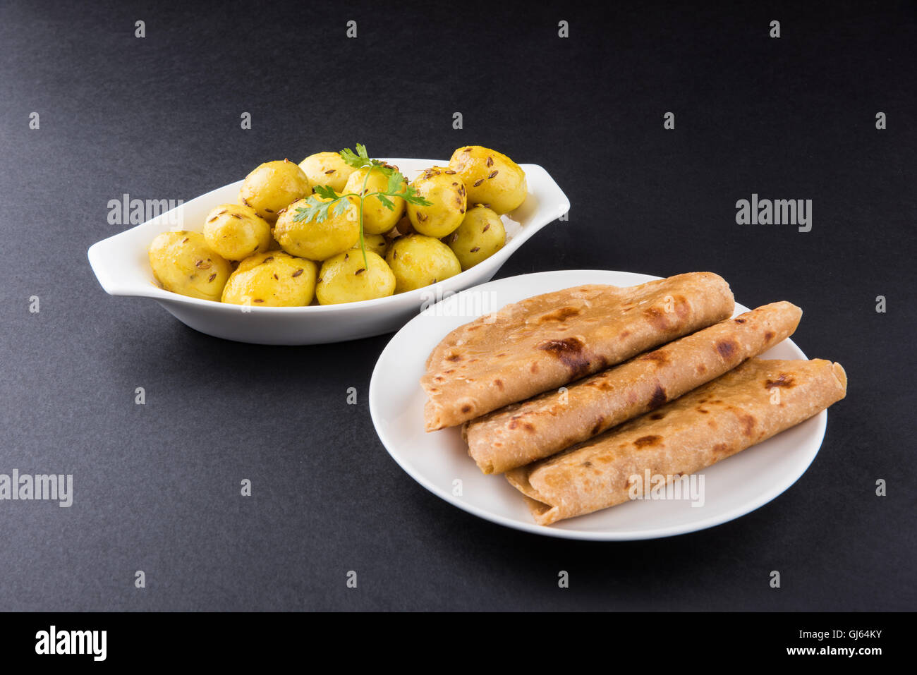 aloo fry or dry potato curry with chapati or roti or indian bread Stock ...