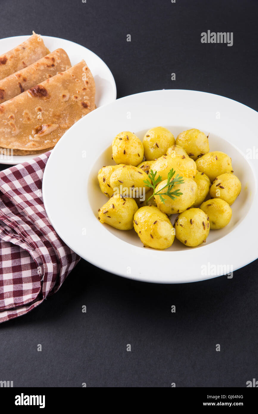 dry potato curry or potato bhaji or aalu bhaji and chapati or paratha ...