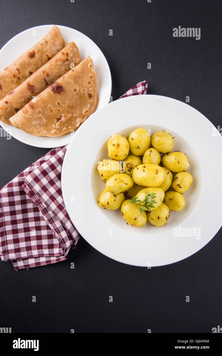 dry potato curry or potato bhaji or aalu bhaji and chapati or paratha ...