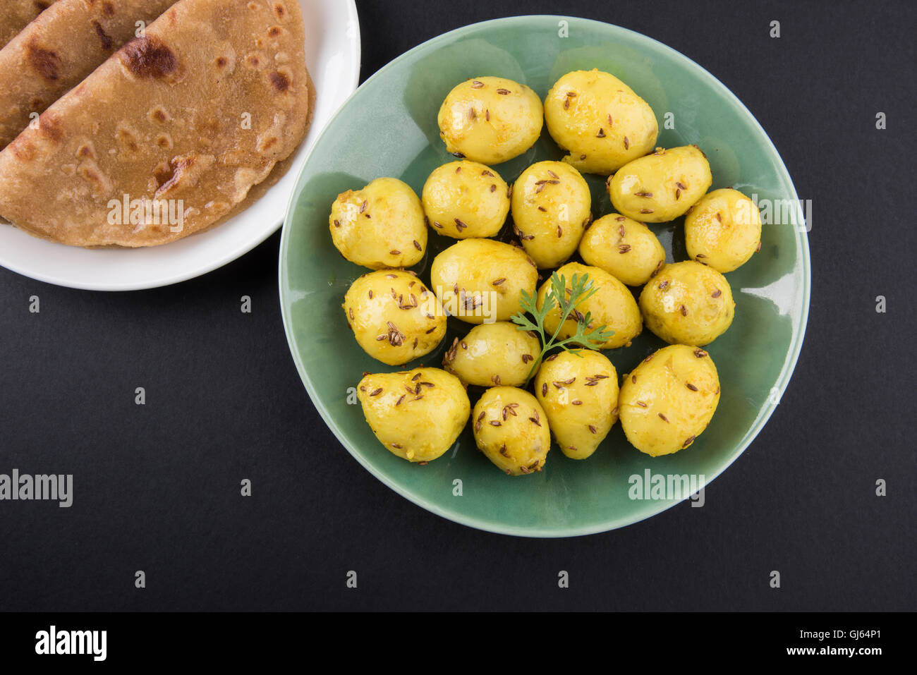 dry potato curry or potato bhaji or aalu bhaji and chapati or paratha ...