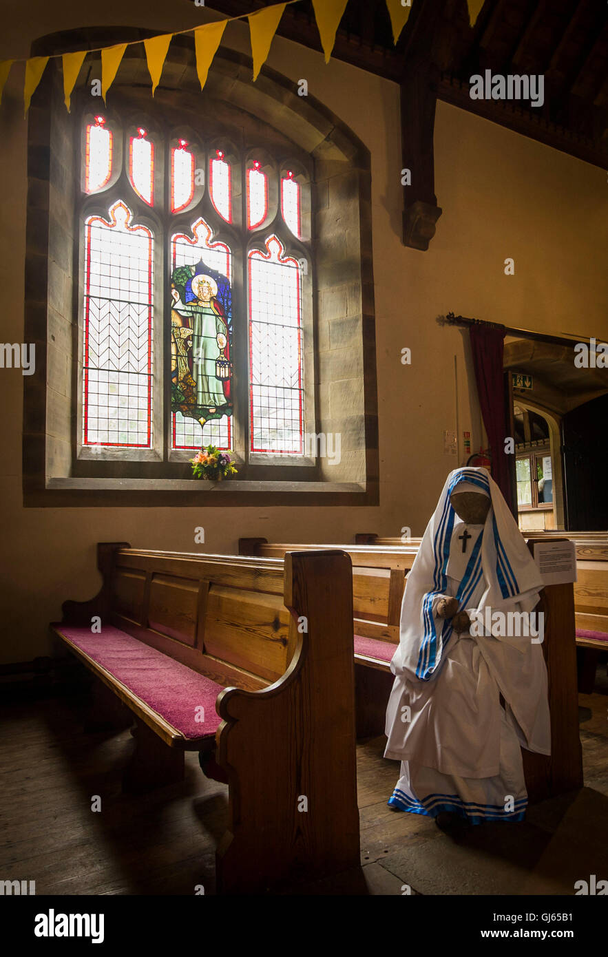 A scarecrow on display in a church during the Kettlewell Scarecrow ...