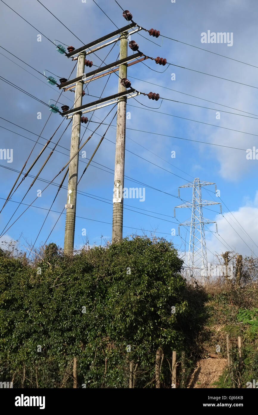 Multiple power lines in rural England, distribution poles and larger ...