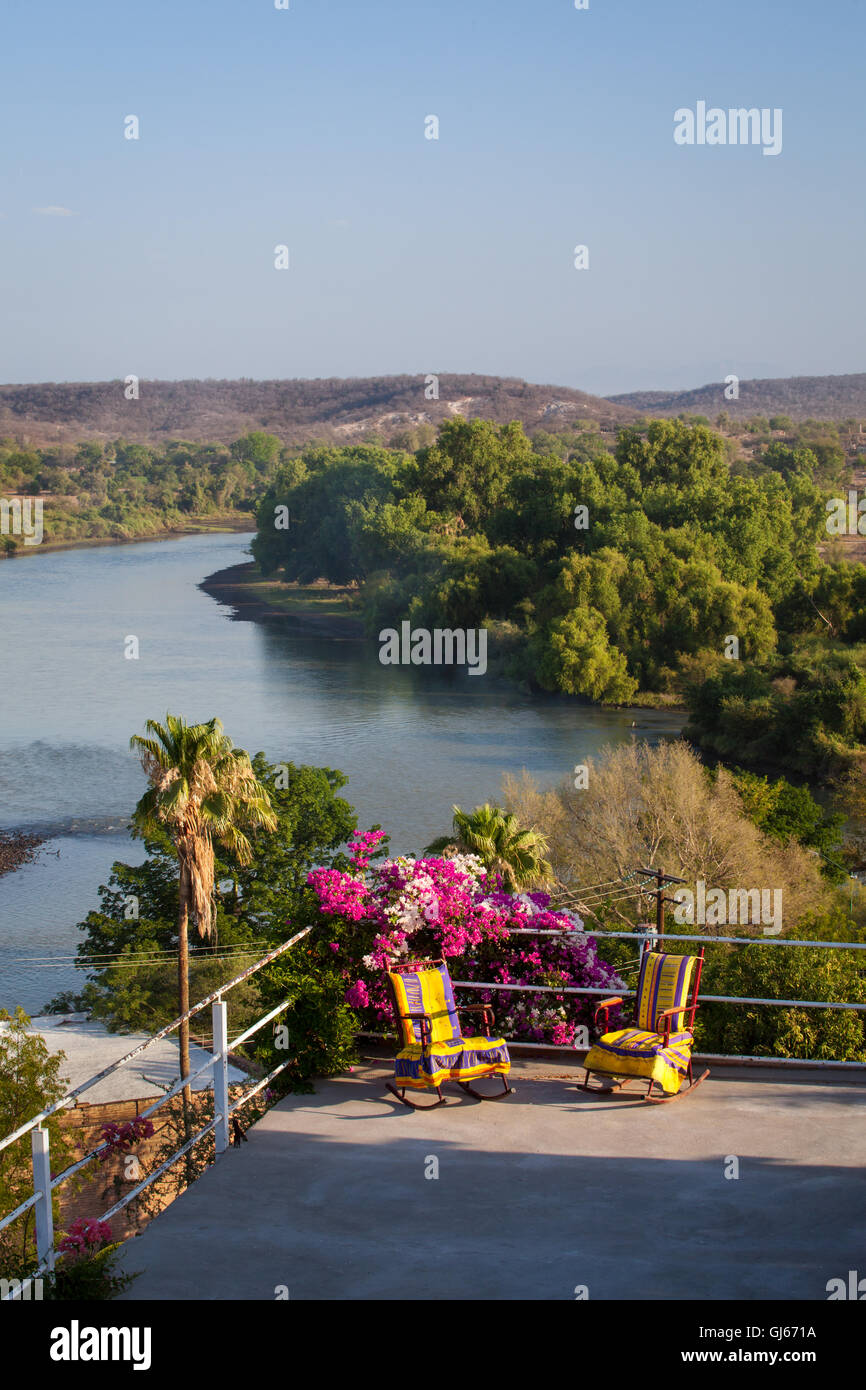 A couple of chairs offer an inviting view of the Fuerte River that ...