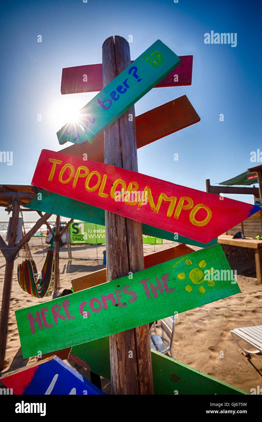 A colorful signpost at Maviri Beach Club points the way to nearby ...