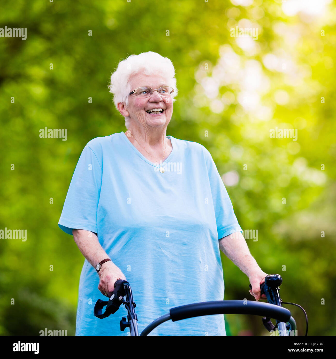 Happy senior handicapped lady with a walking disability enjoying a walk ...