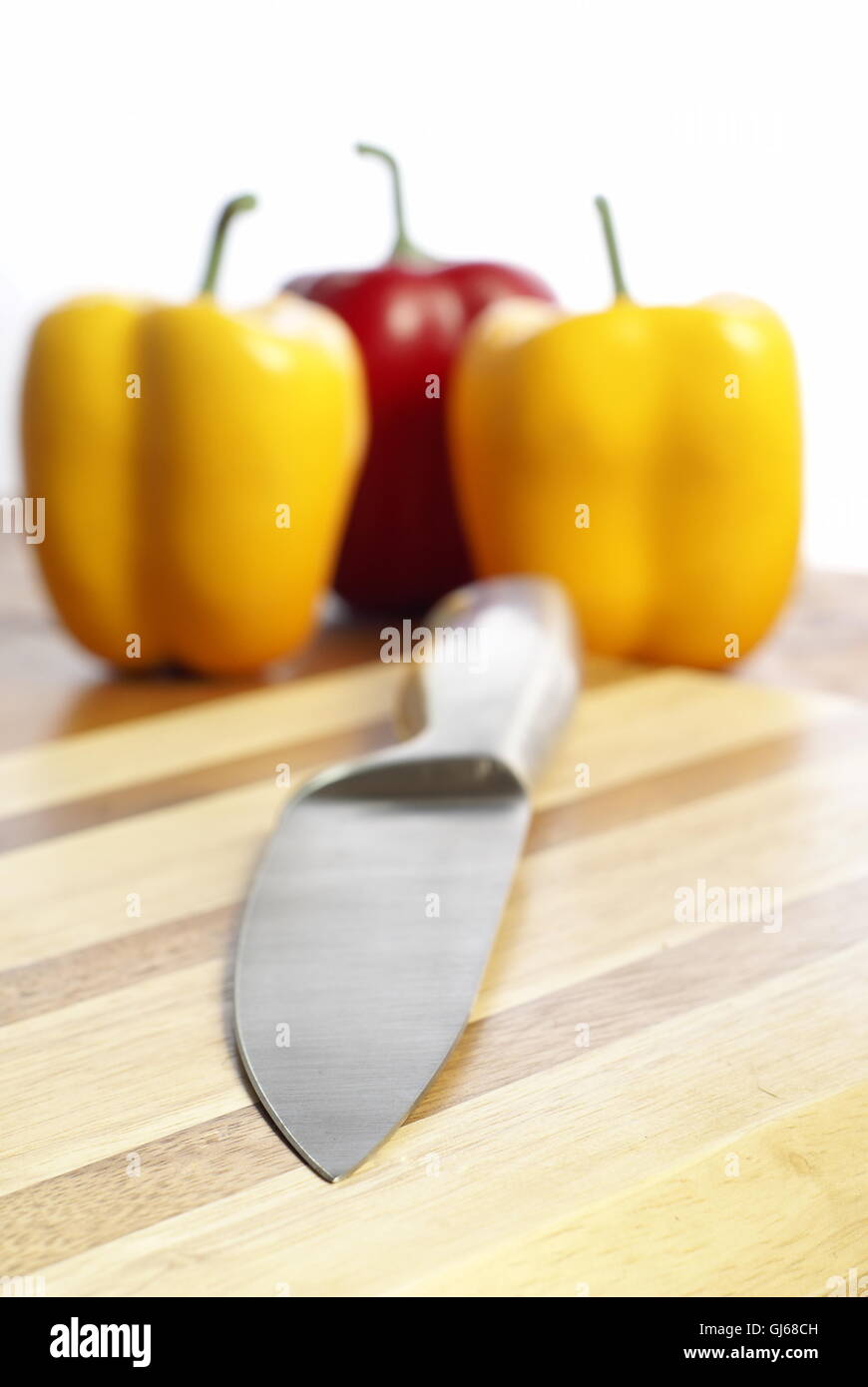 Knife and capsicum on chopping board Stock Photo - Alamy