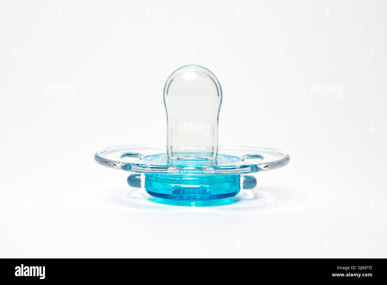 Clear blue pacifier isolated Stock Photo - Alamy