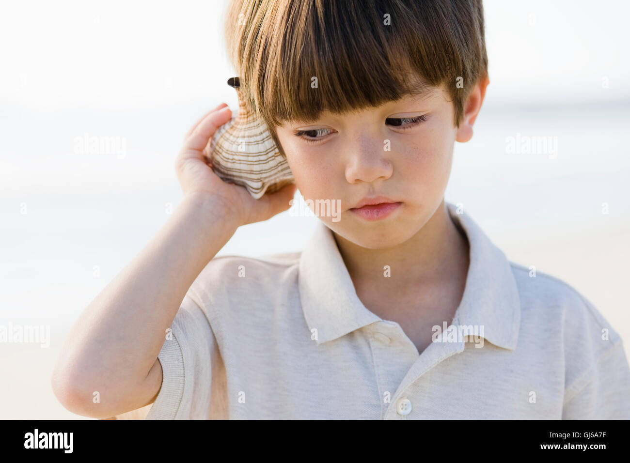 Boy Holding Shell Stock Photo - Alamy