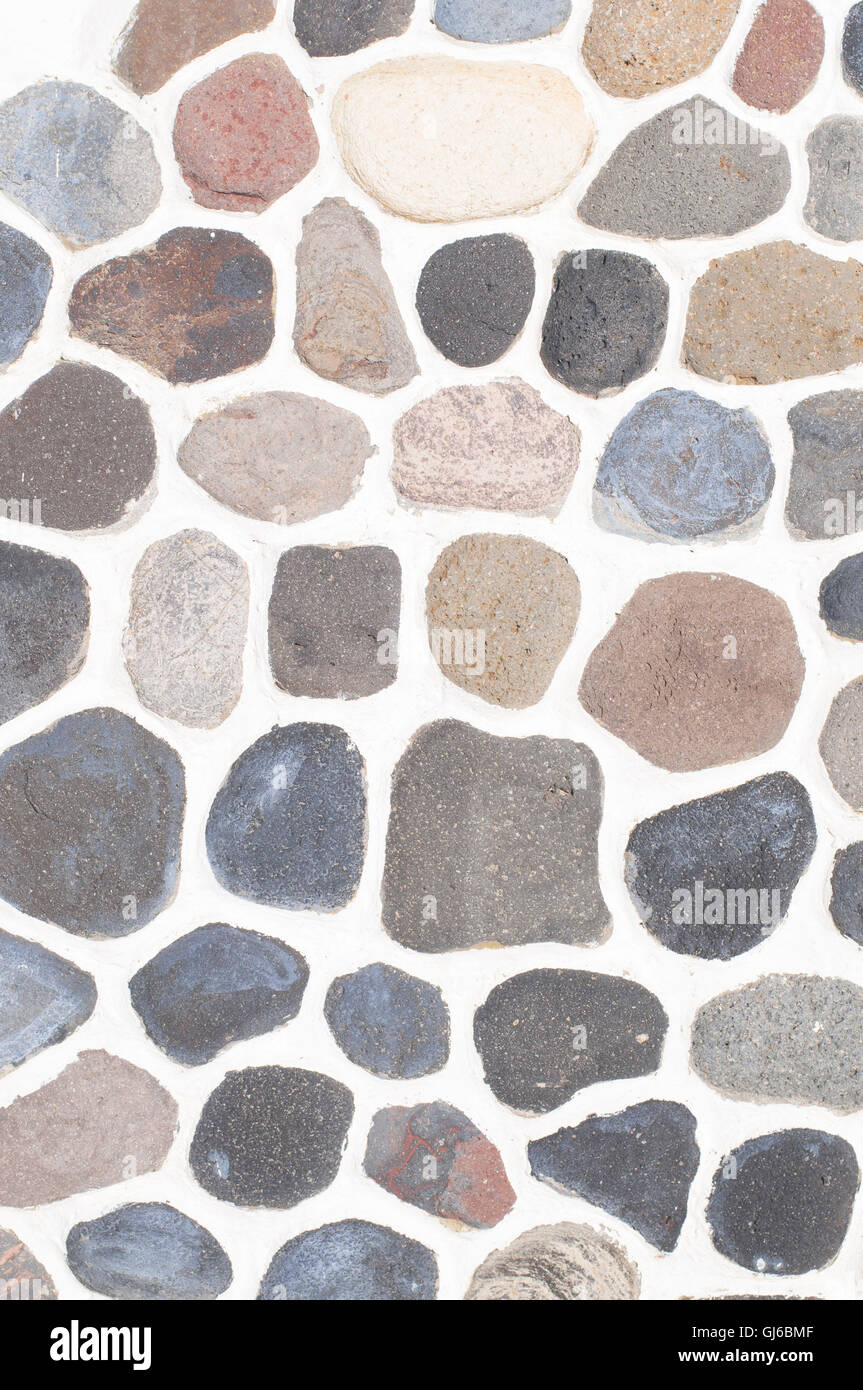 view to stone wall made of volcanic stones, Oia, Santorini, Greece ...