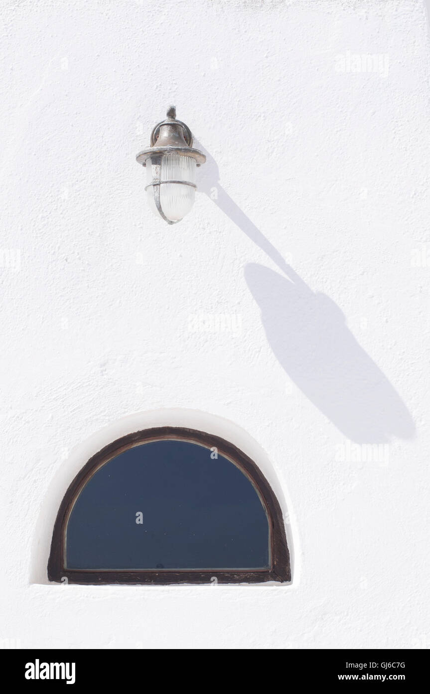 Lamp and window on whitewashed wall, Oia, Santorini, Greece Stock Photo ...
