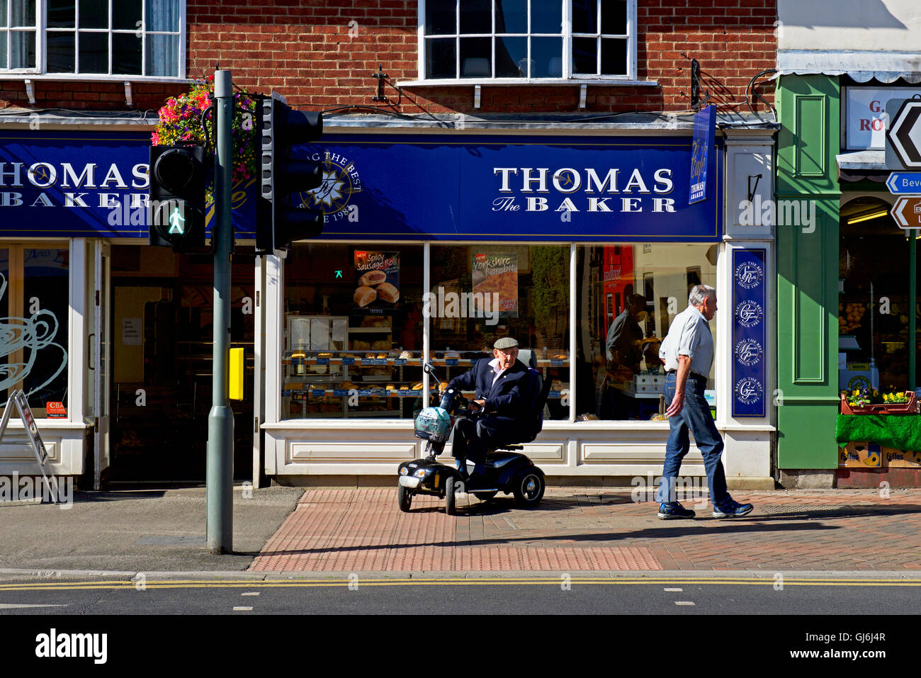 Thomas the Baker shop and man on mobility scooter, Driffield, East ...
