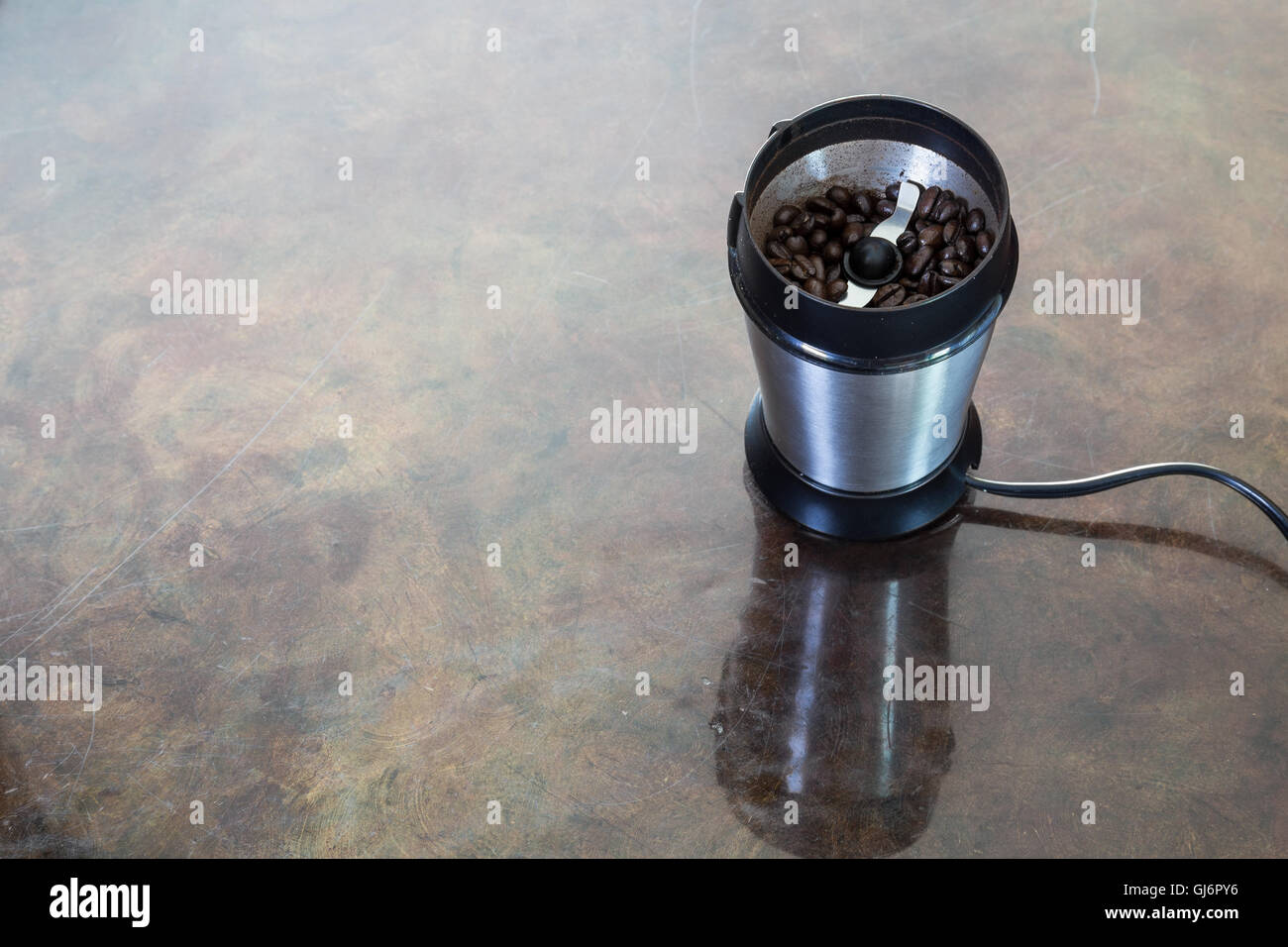 Electric coffee grinder with beans inside Stock Photo - Alamy