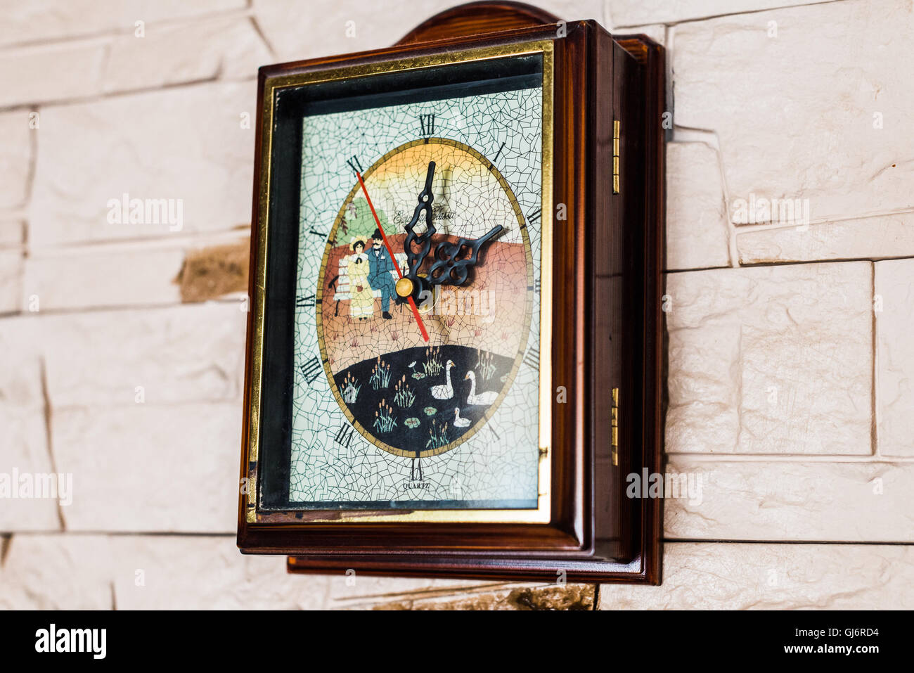 wall clock hanging on the white stone wall Stock Photo - Alamy