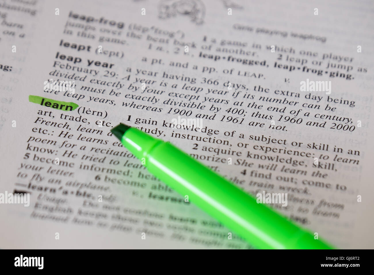 The word learn is highlighted and defined in a dictionary Stock Photo ...