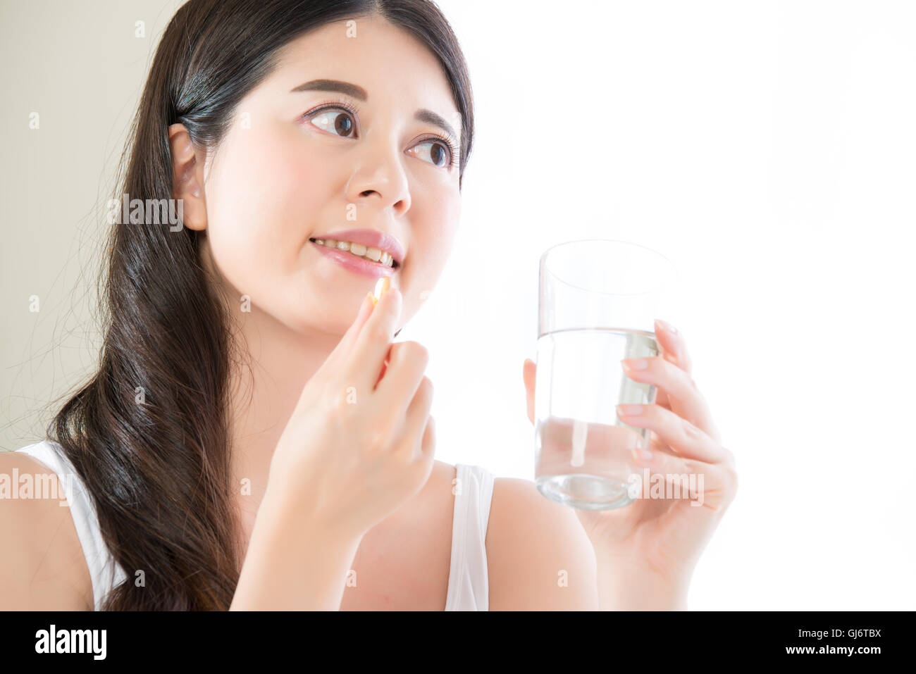 beautiful asian women eating nutritional fish oil supplement for ...